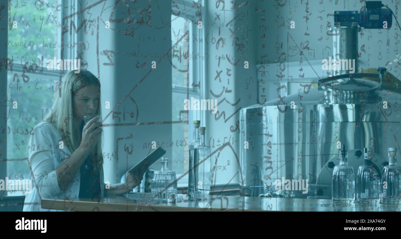 Image of scientific formulas over female scientist using tablet and ...
