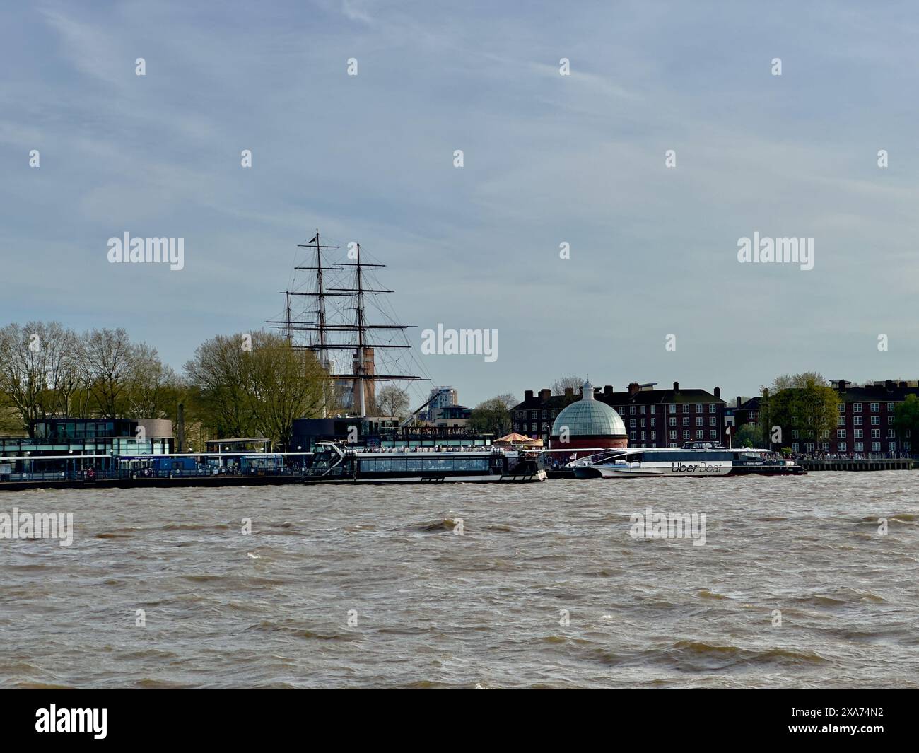 A ferry passing a massive ship in the ocean Stock Photo - Alamy