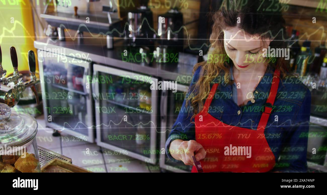 Image of financial data processing over woman holding paying terminal ...