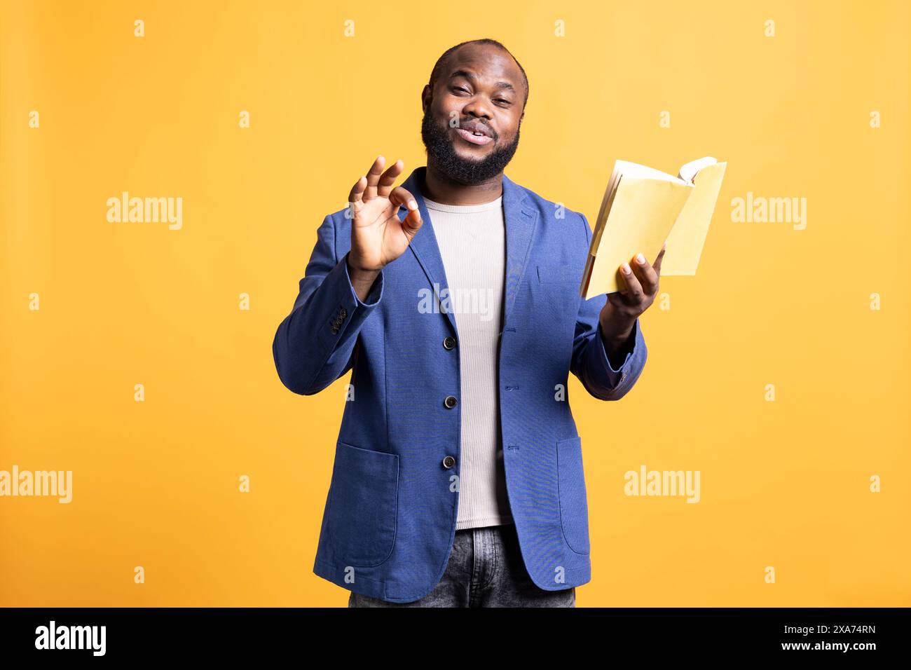 Portrait of jolly african american man recommending interesting book ...