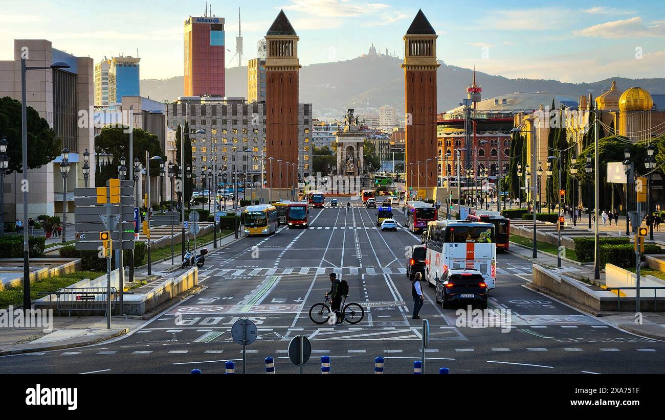 A urban scene with cars and buses drive on city street amidst ...