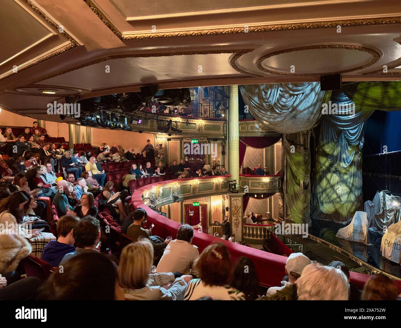 A Crowded circular stage with people sitting and observing the scene ...