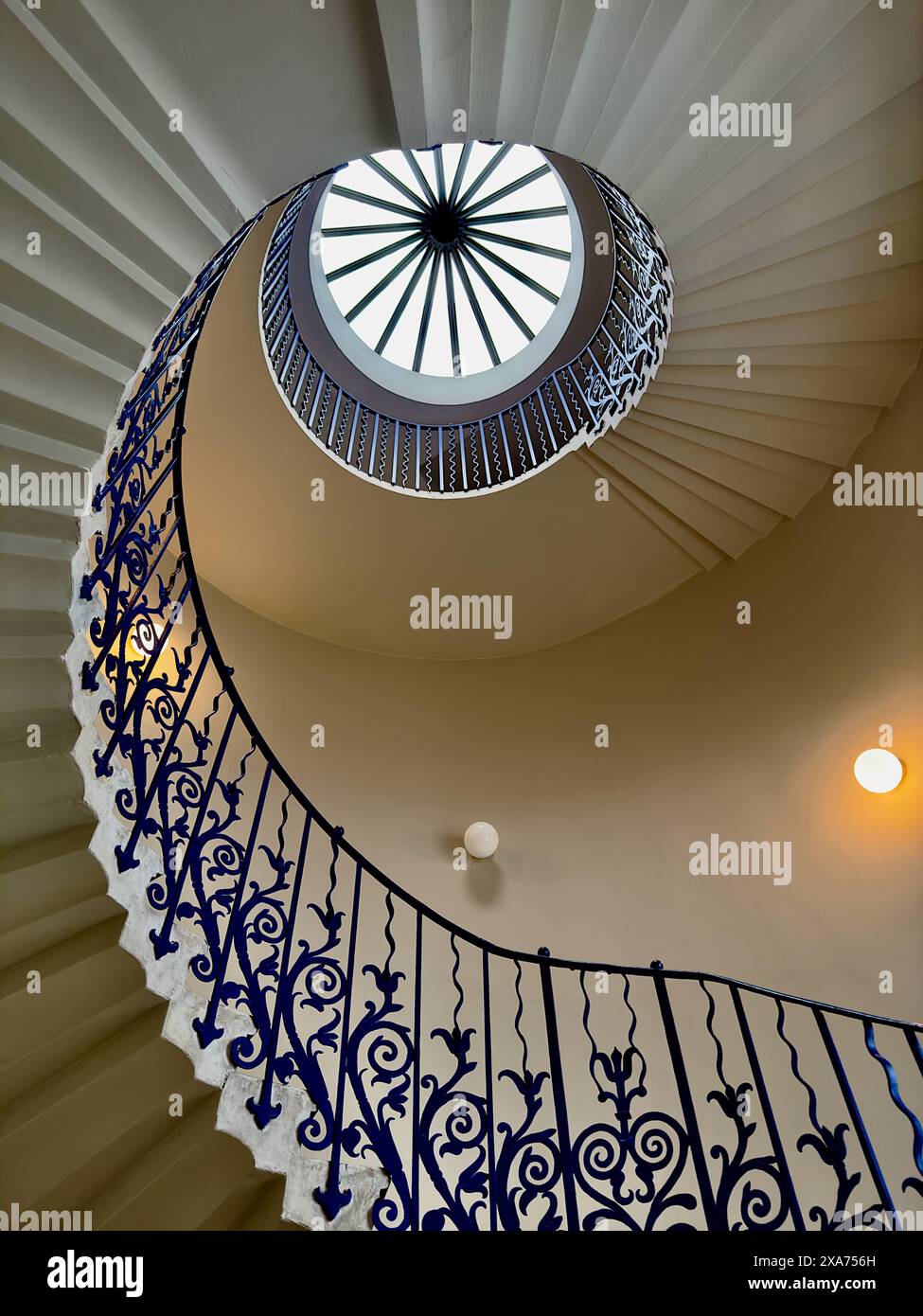 A spiral staircase with blue handrails and dome glass window Stock ...