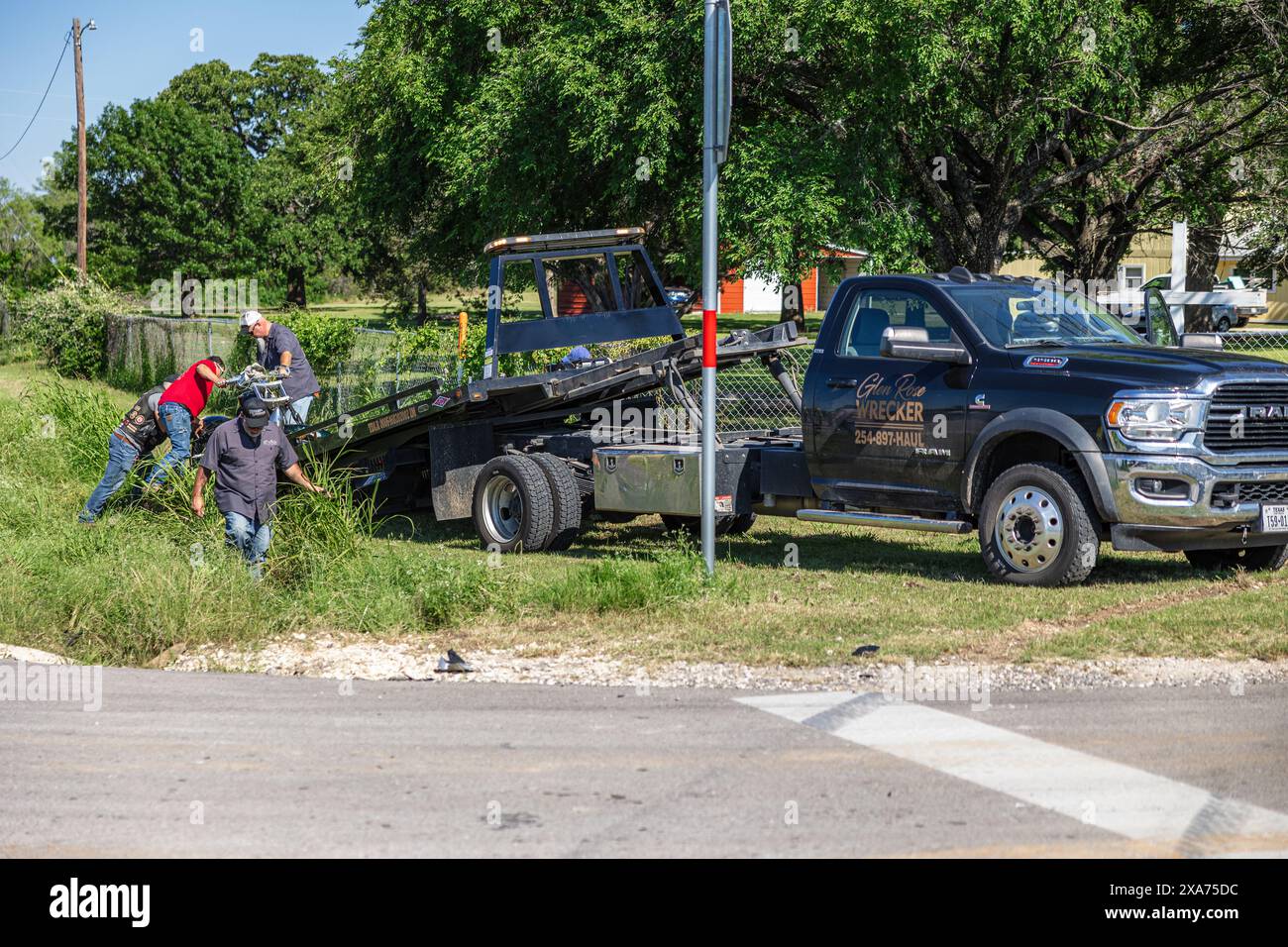 A group of people standing on the road near vehicles after an accident ...