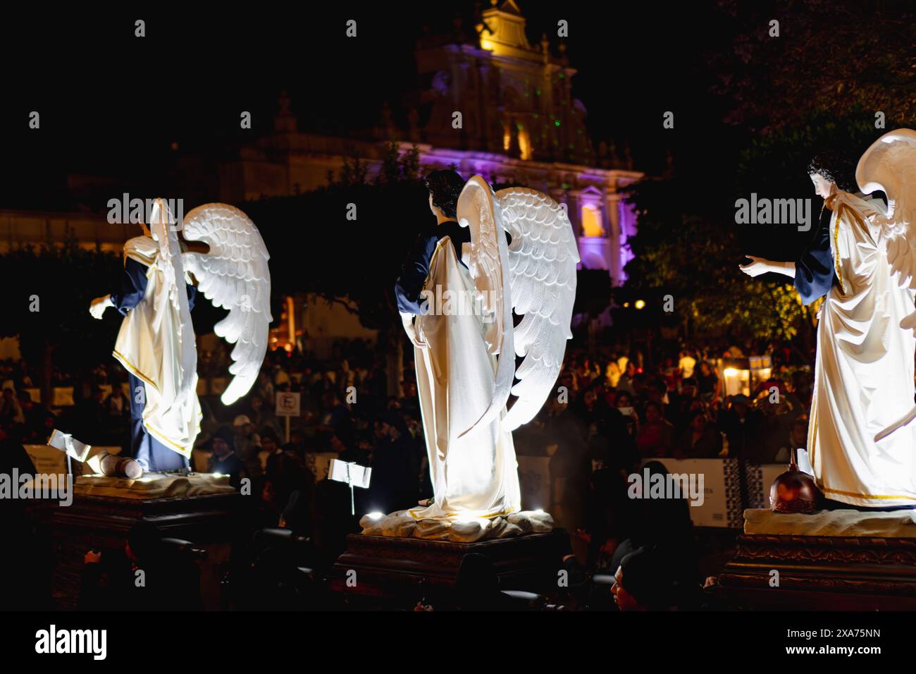 A cluster of angels statues with lights on wooden platform Stock Photo ...