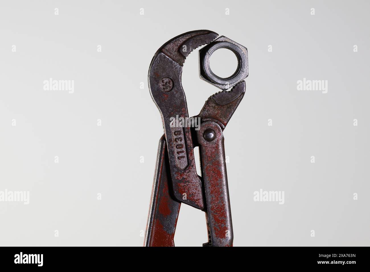 Vintage pipe wrench with rust and metal handles on white background ...