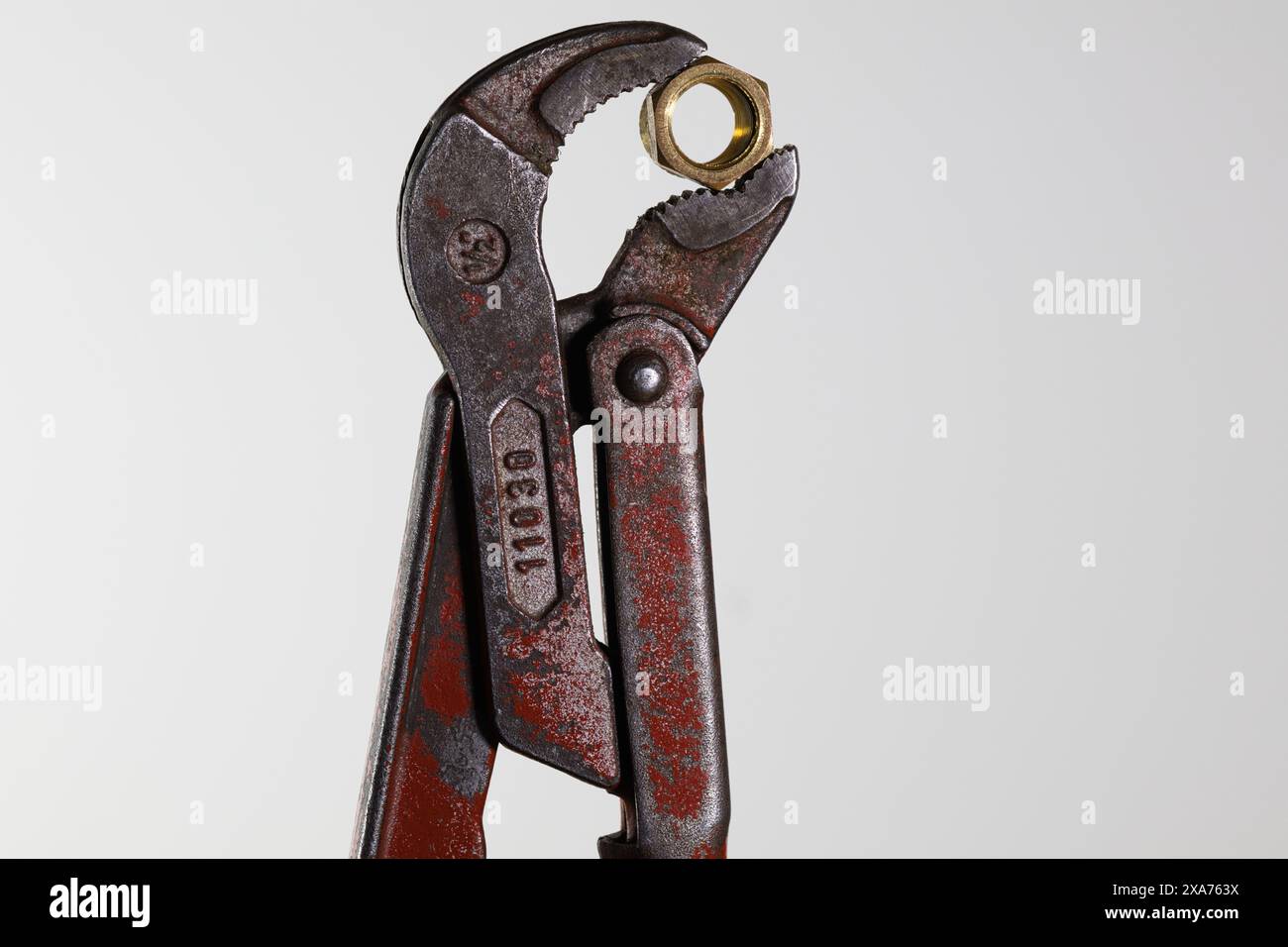 Vintage pipe wrench with rust and metal handles on white background ...