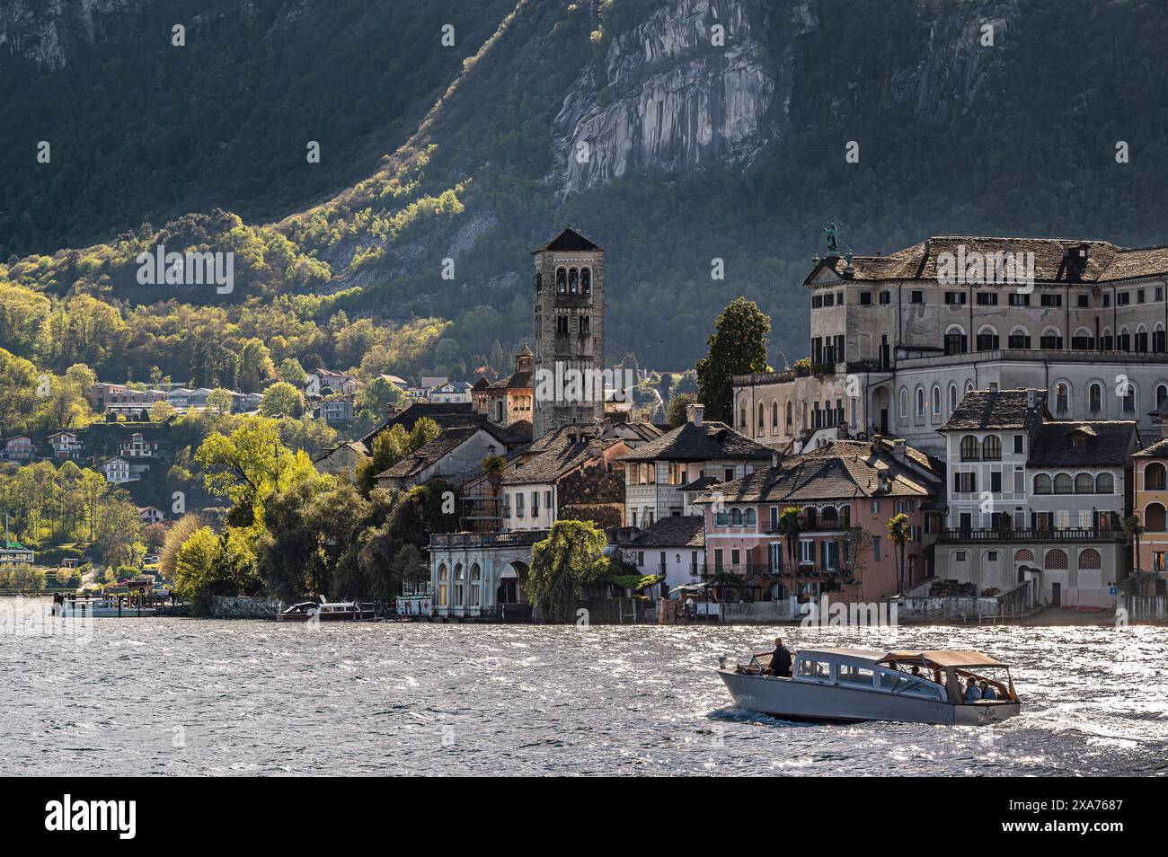 Motorboat in front of island, view of Isola San Giulio from the port of ...