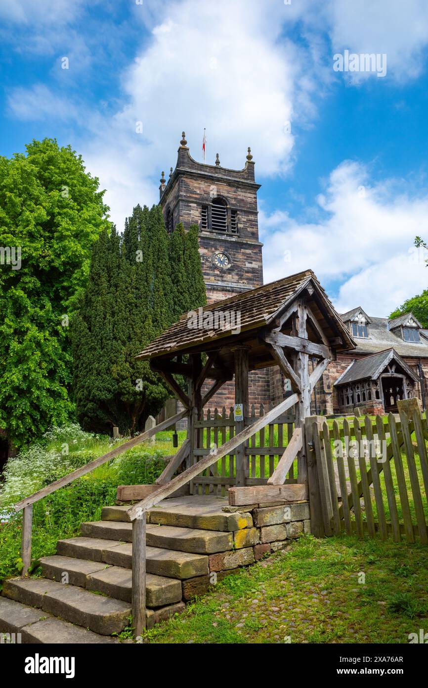 Historic English stone church with wooden lychgate and bell tower ...