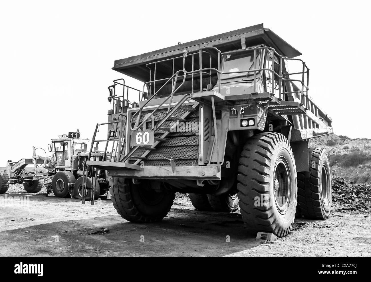 An army dump truck parked near machinery on dirt ground Stock Photo - Alamy