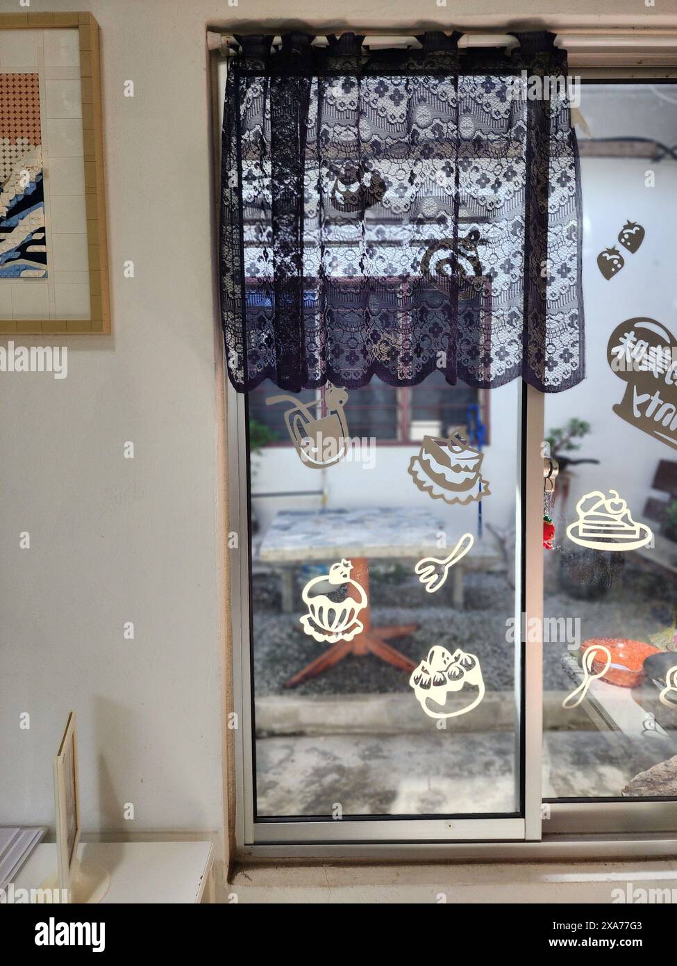 A window adorned with cartoon characters and heart-patterned curtains ...
