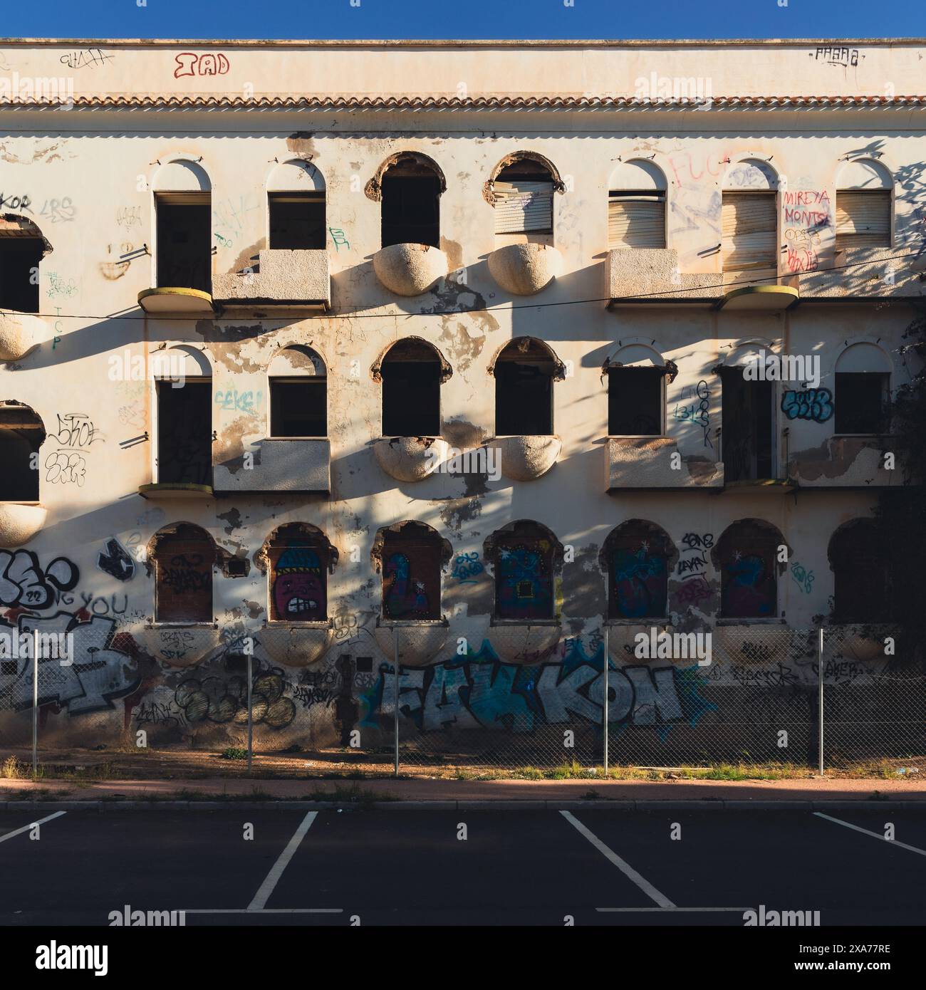 Graffiti-covered wall of a beautiful old building near fence and ...
