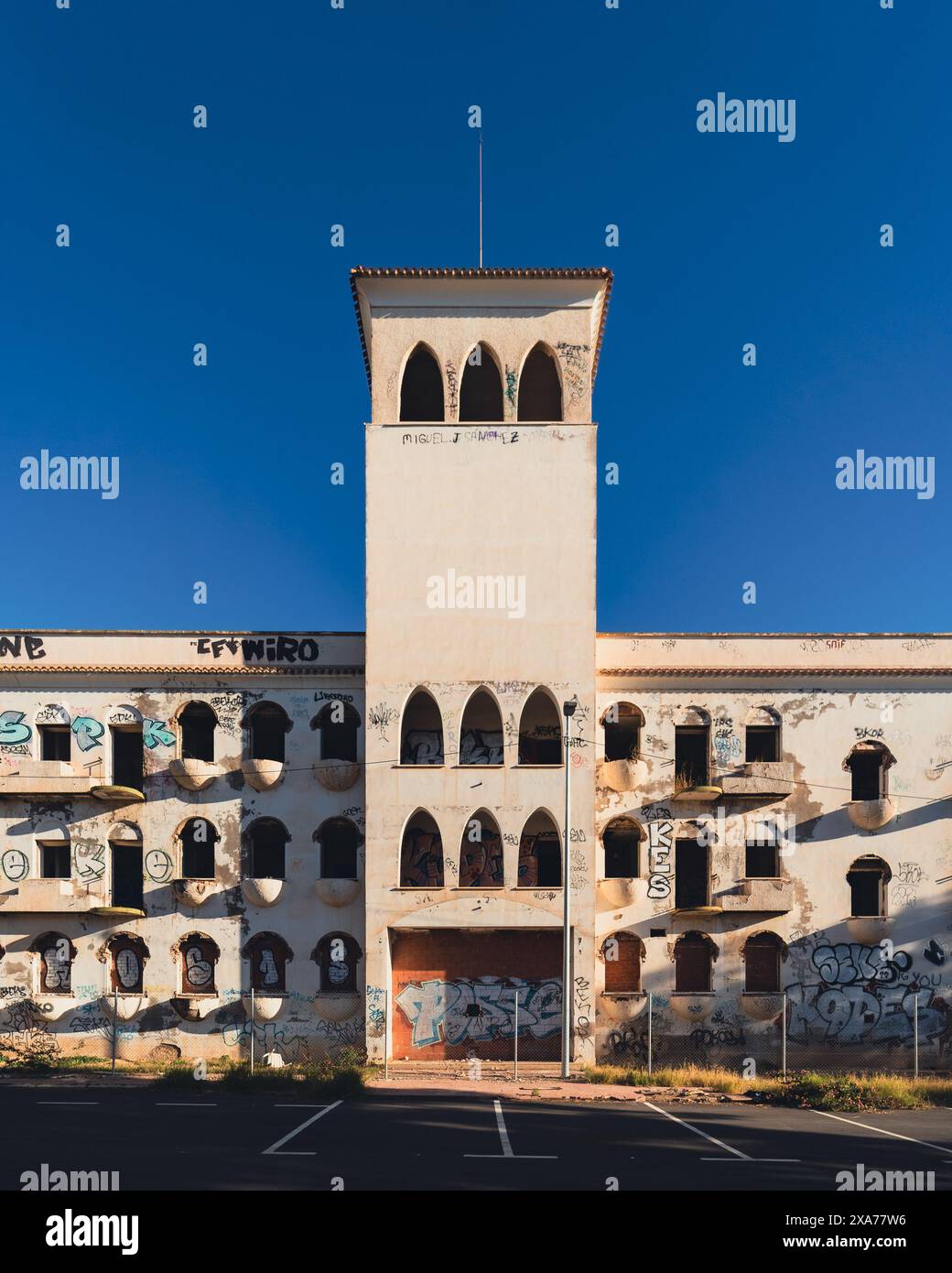 An aged abandoned white structure covered in colorful graffiti art Stock Photo - Alamy