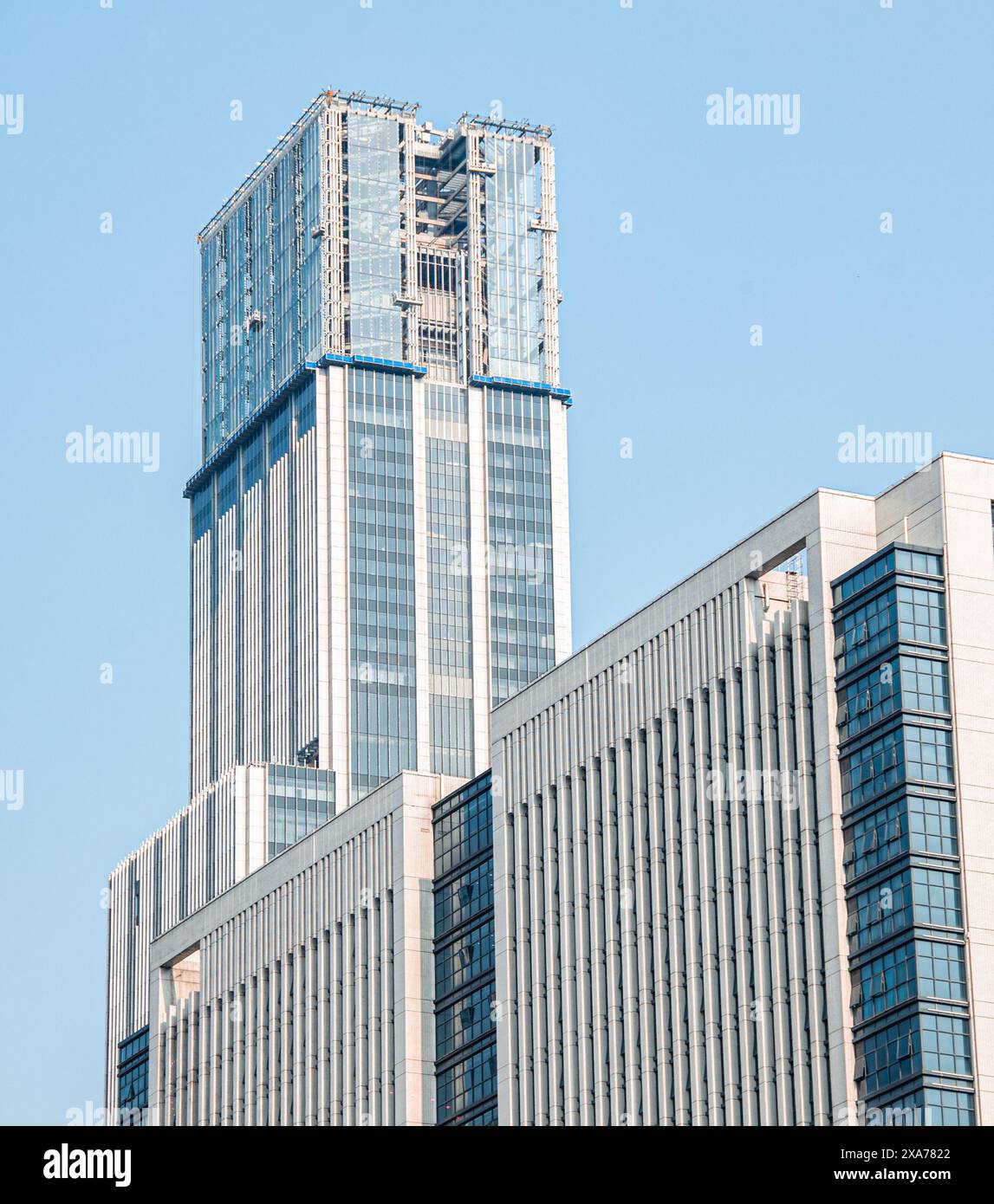 A big building in the front with a towering skyscraper featuring ...