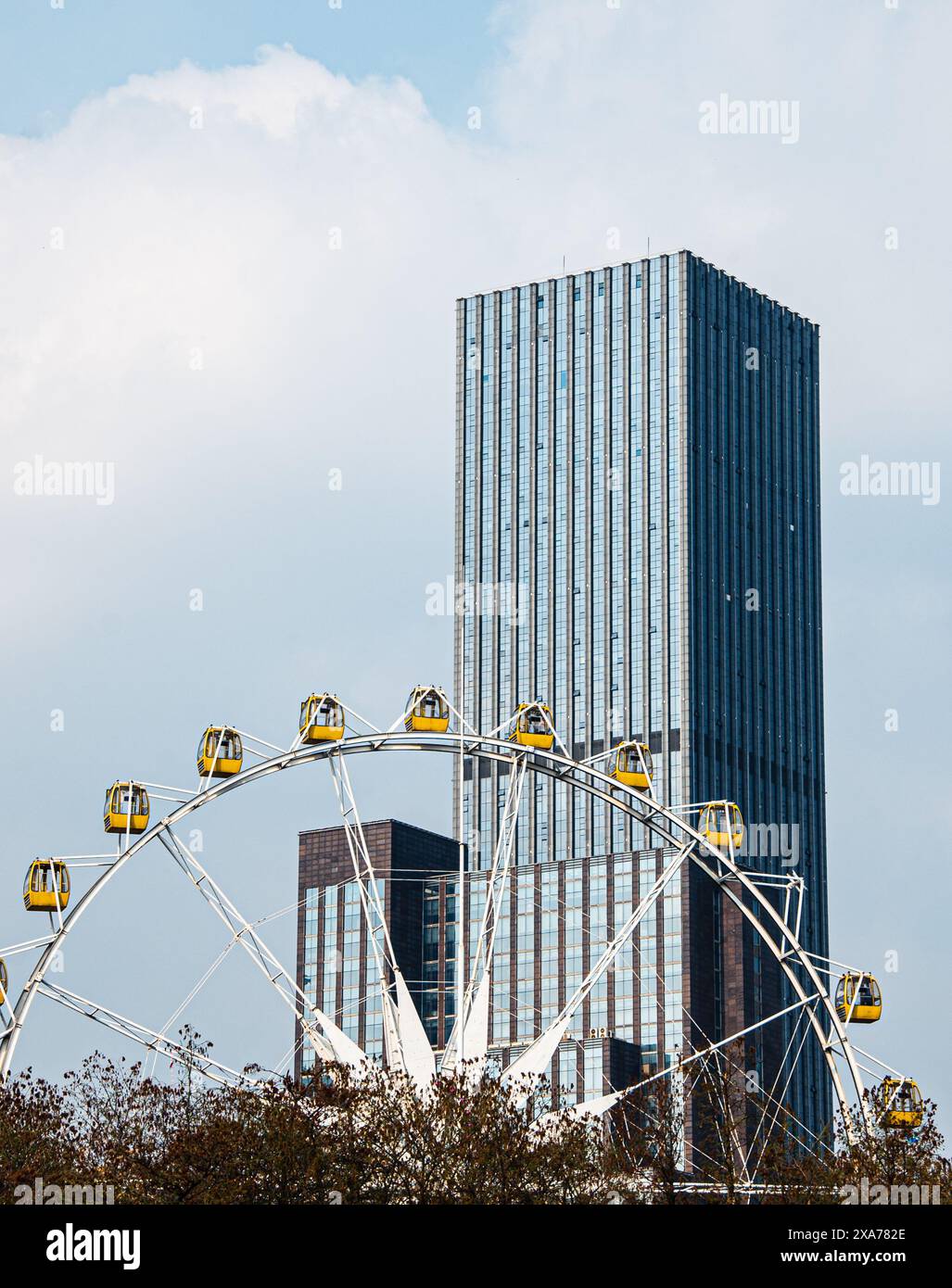 Ferris wheel in front of a skyscraper located in Wuhan Stock Photo - Alamy