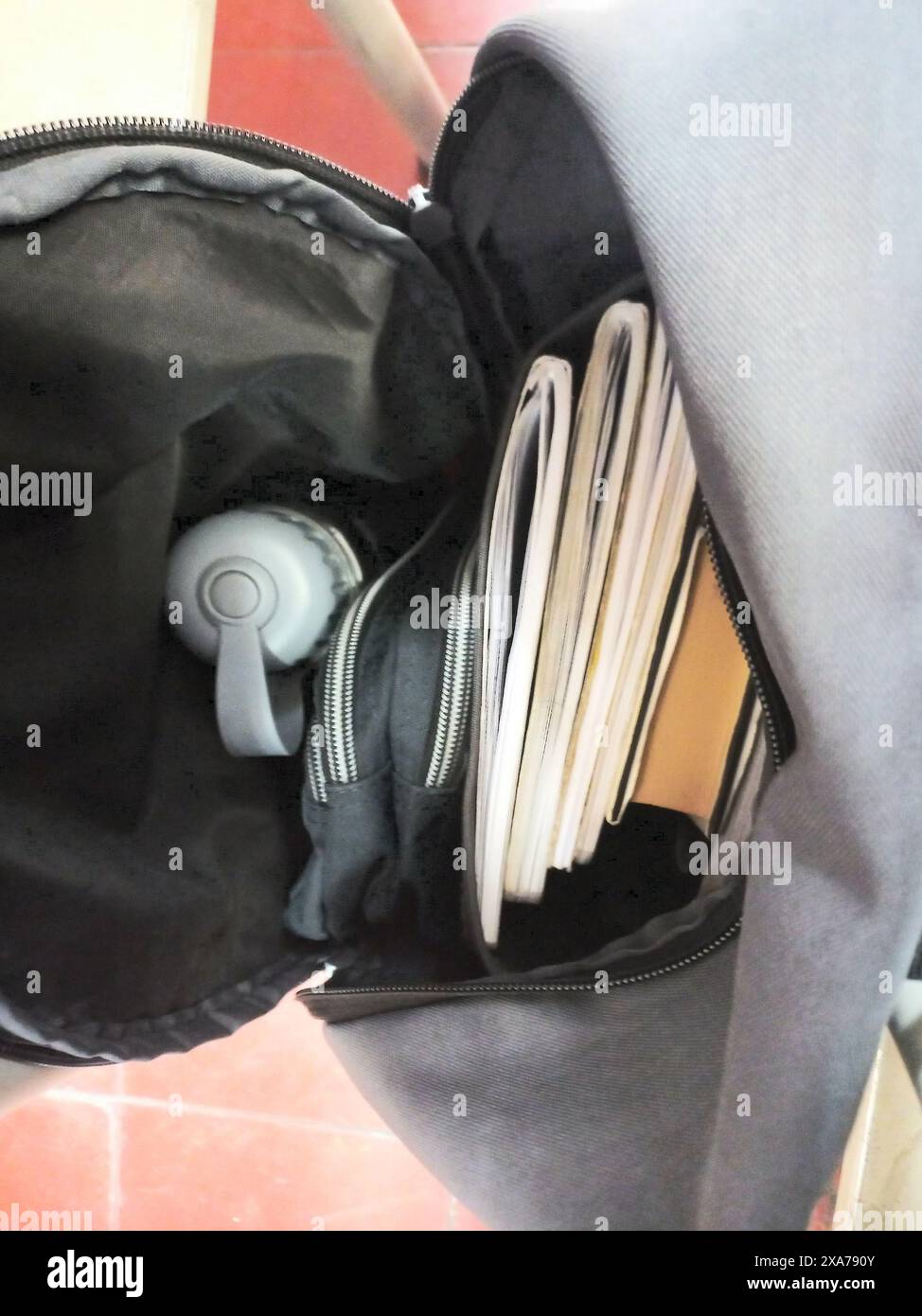 An open bag with notes and a water bottle inside Stock Photo - Alamy