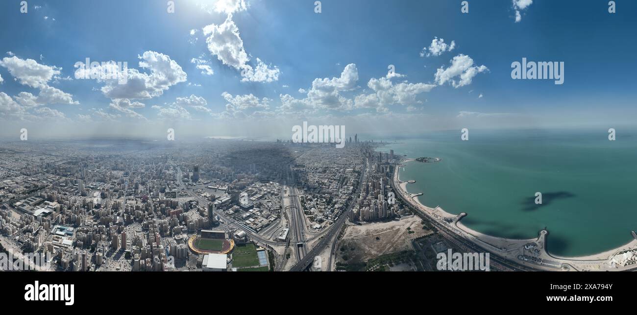 An aerial view of a sprawling city skyline across the water Stock Photo ...