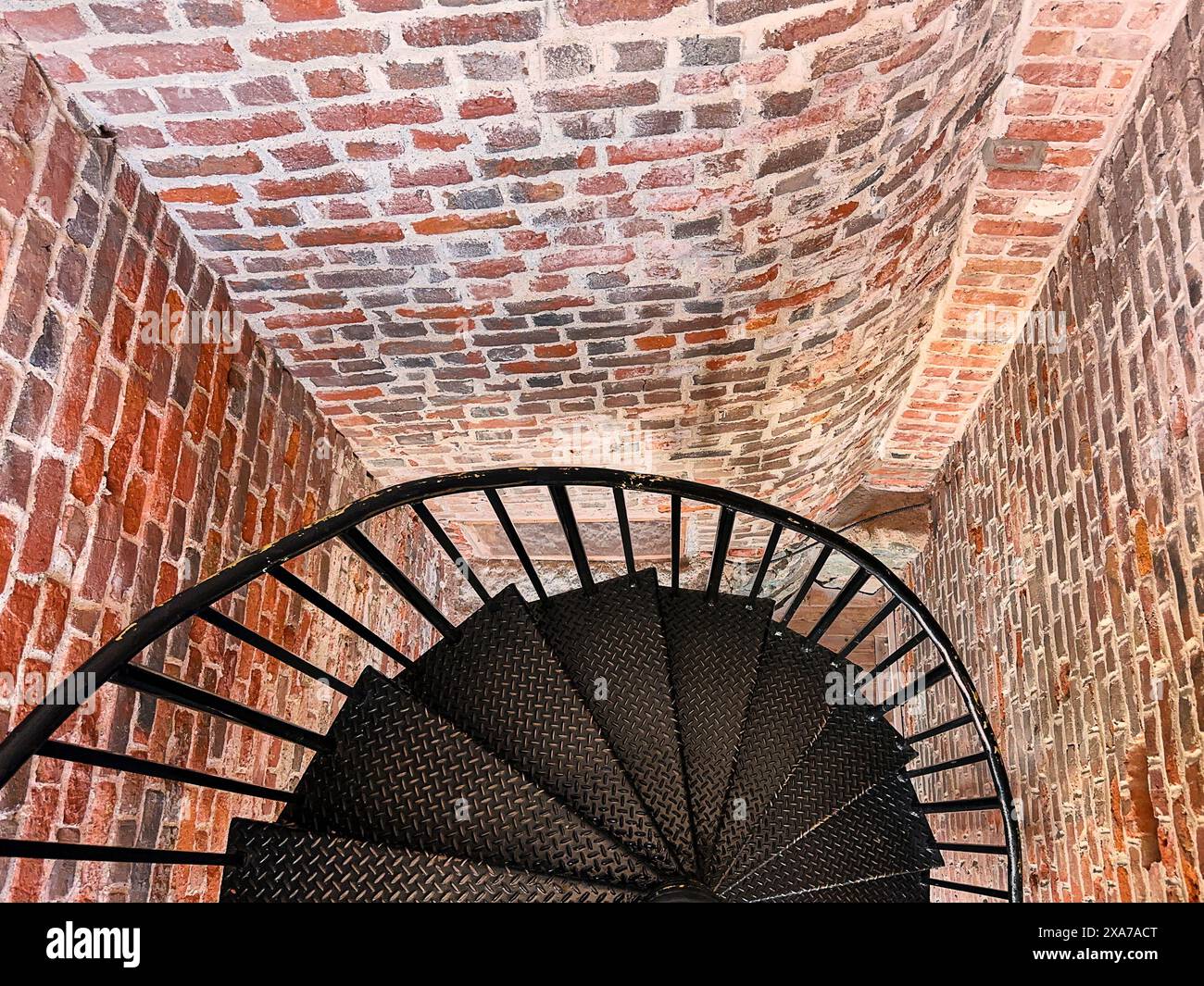 Closeup of the black wrought iron staircase railing surrounded by red ...