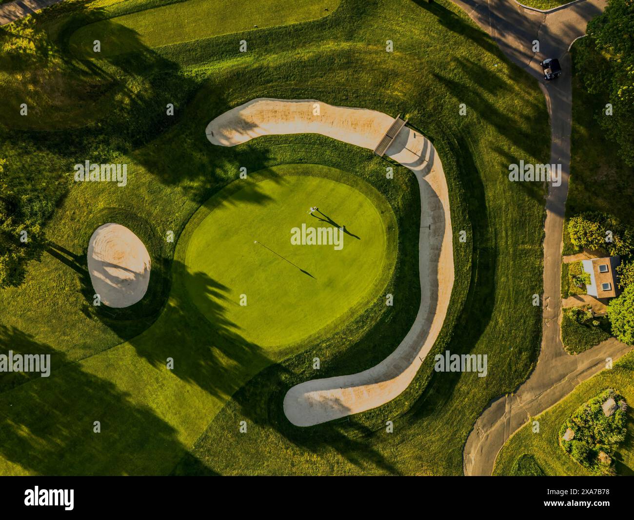 An aerial view of a beautifully landscaped golf course at the start of ...