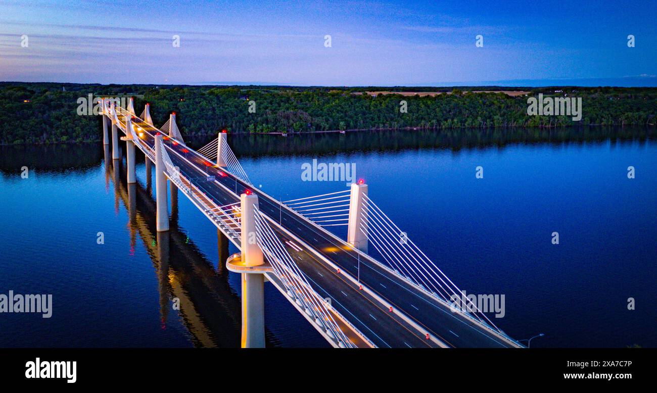 Illuminated St Croix River bridge over water, encircled by buildings ...