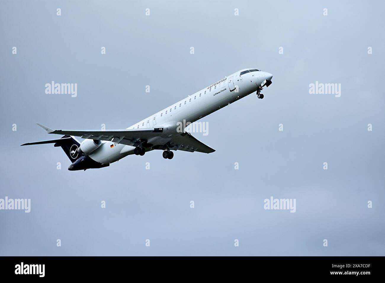 A high-flying airplane ascending into the bright sky during takeoff ...