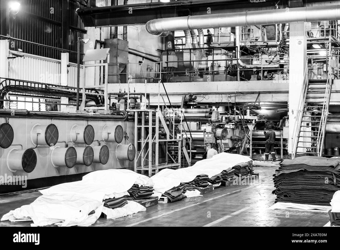 A monochrome of machinery in a factory used for rubber assembly line in ...