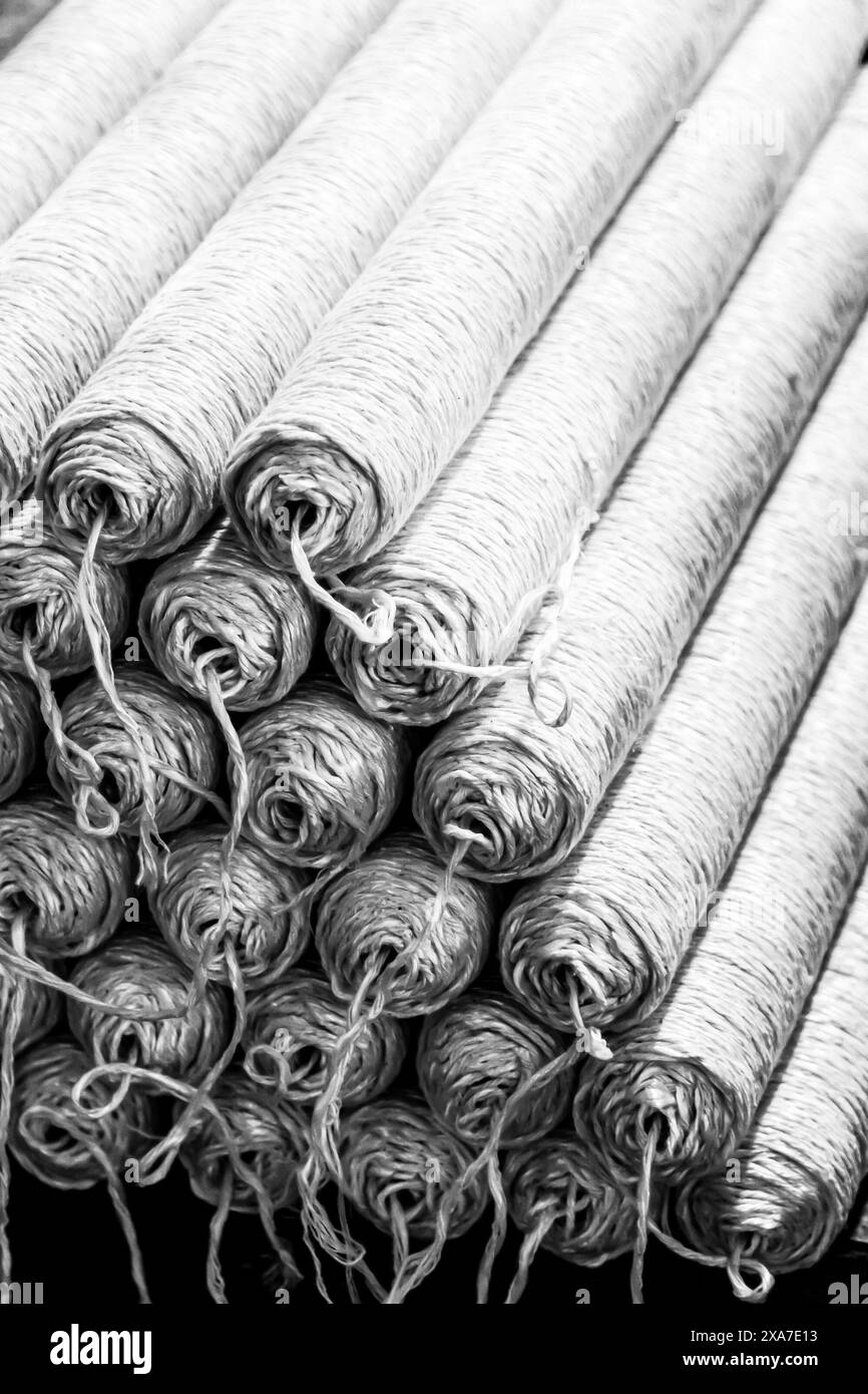 A grayscale of cotton thread spool on the loom assembly line in ...