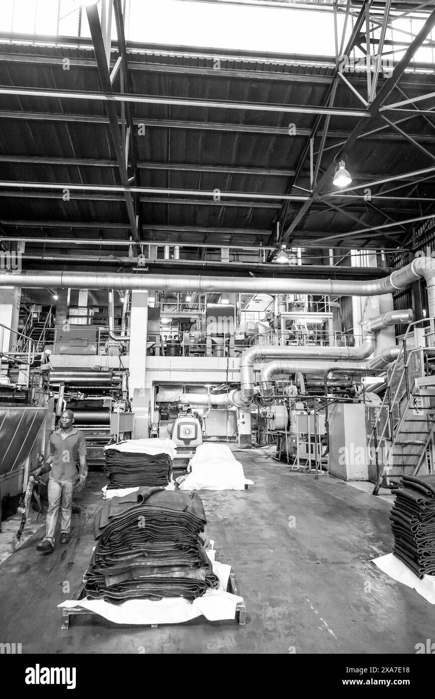 A monochrome of machinery in a factory used for rubber assembly line in ...
