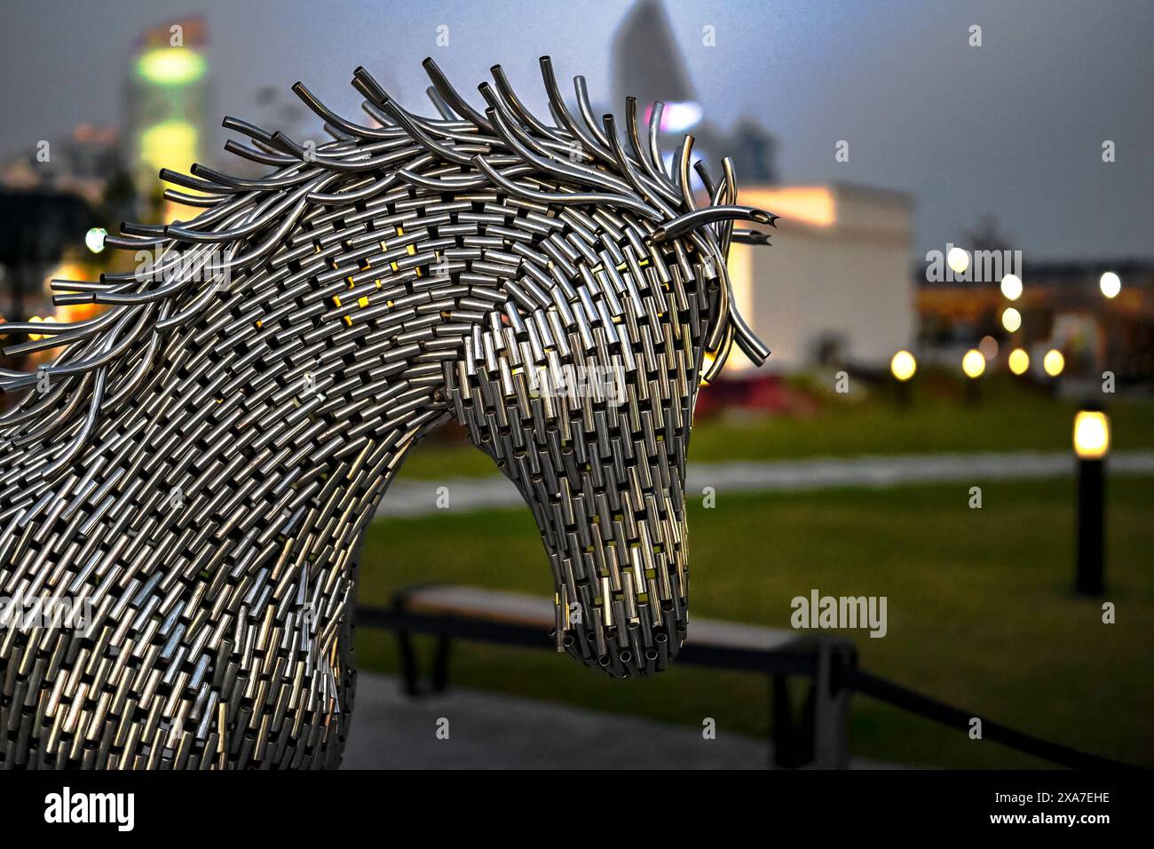 A metal wire horse sculpture on sidewalk near green grass Stock Photo ...