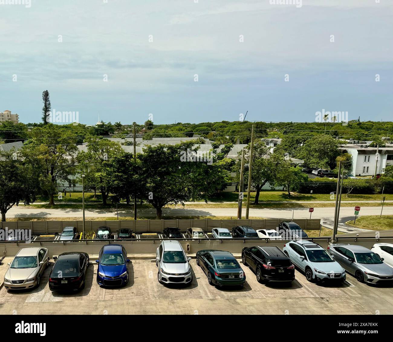 An image of a parking lot with five cars, one of them being blue Stock ...