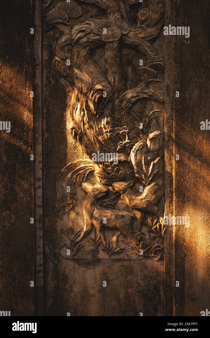 A wooden panel featuring intricate dragon and boar design Stock Photo ...