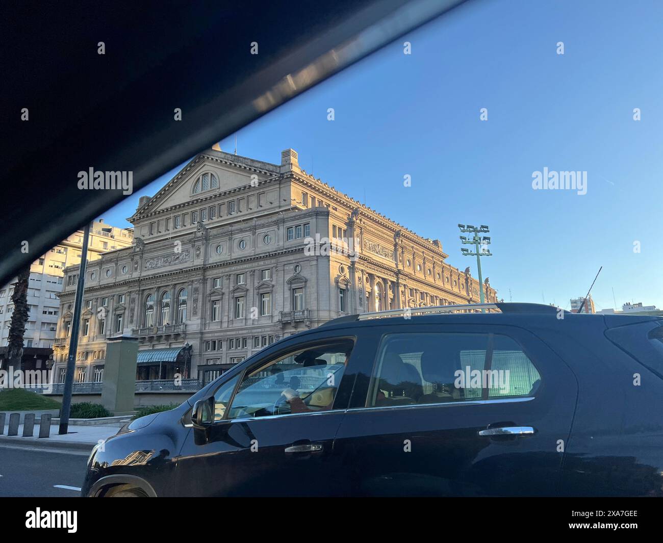A car driving on road with building in distance Stock Photo - Alamy