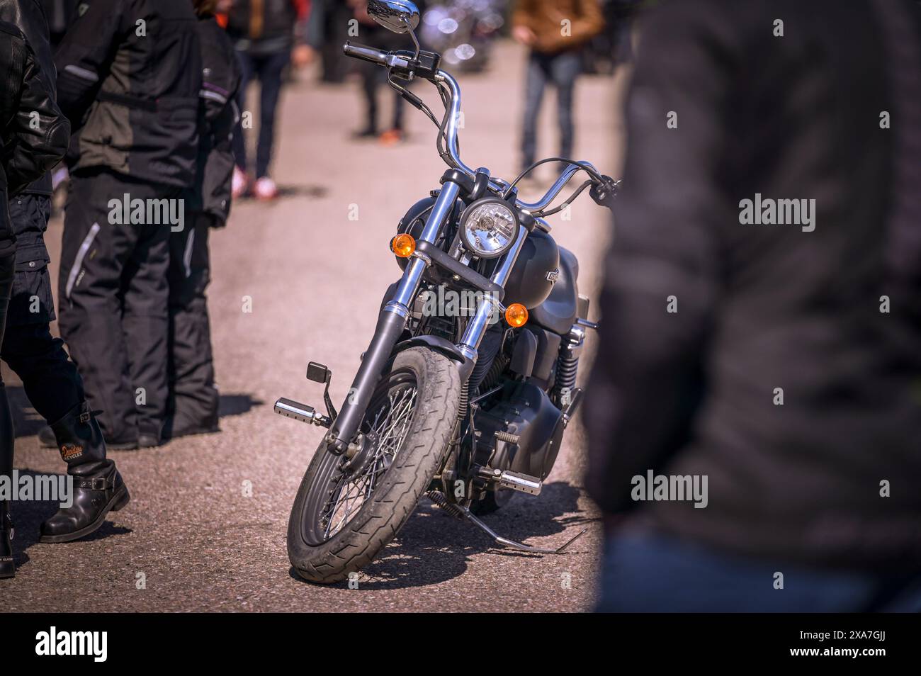 A motorcycle standing among people at a biker show Stock Photo - Alamy