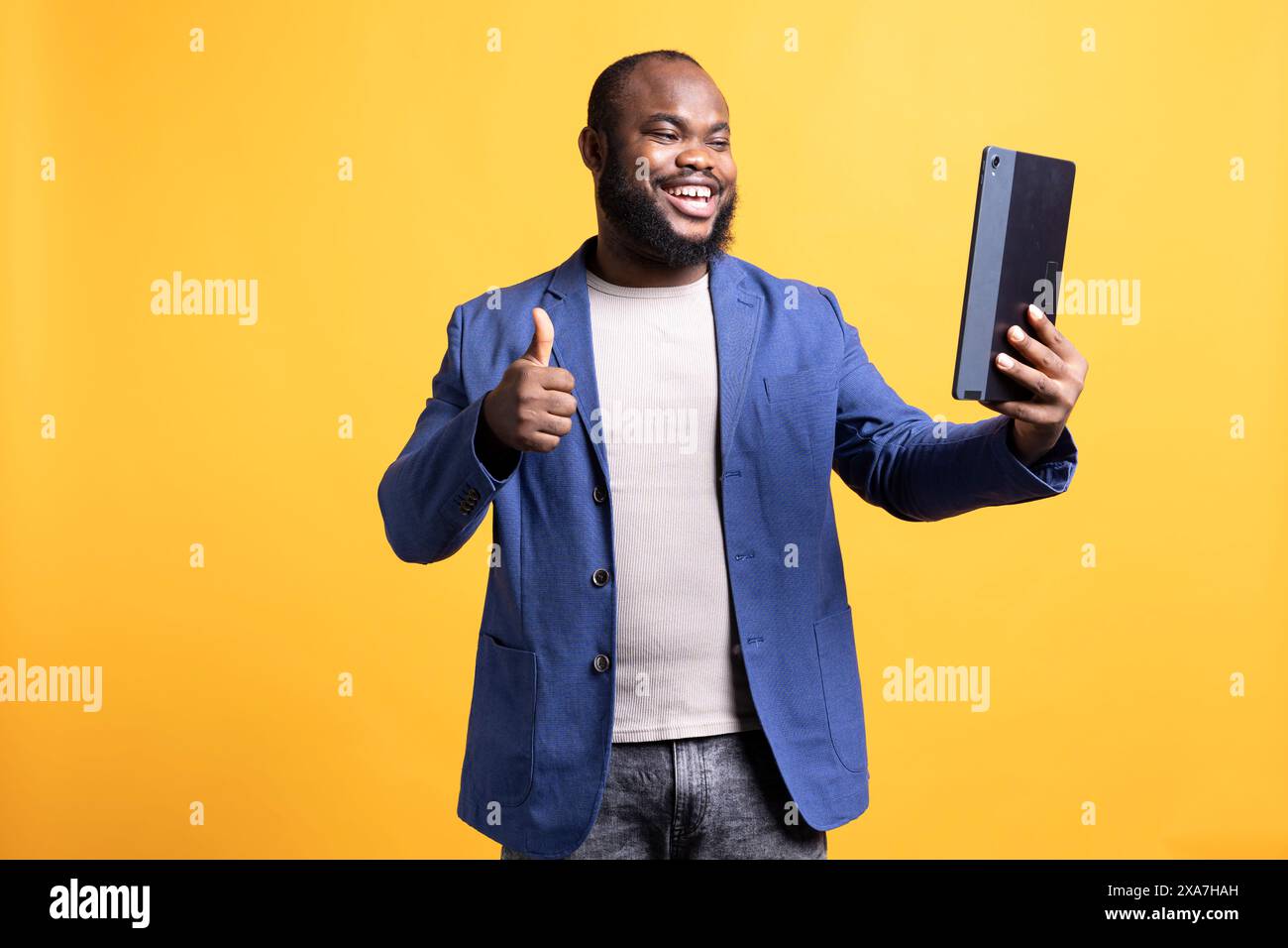Cheerful man agreeing with friends during teleconference meeting using ...