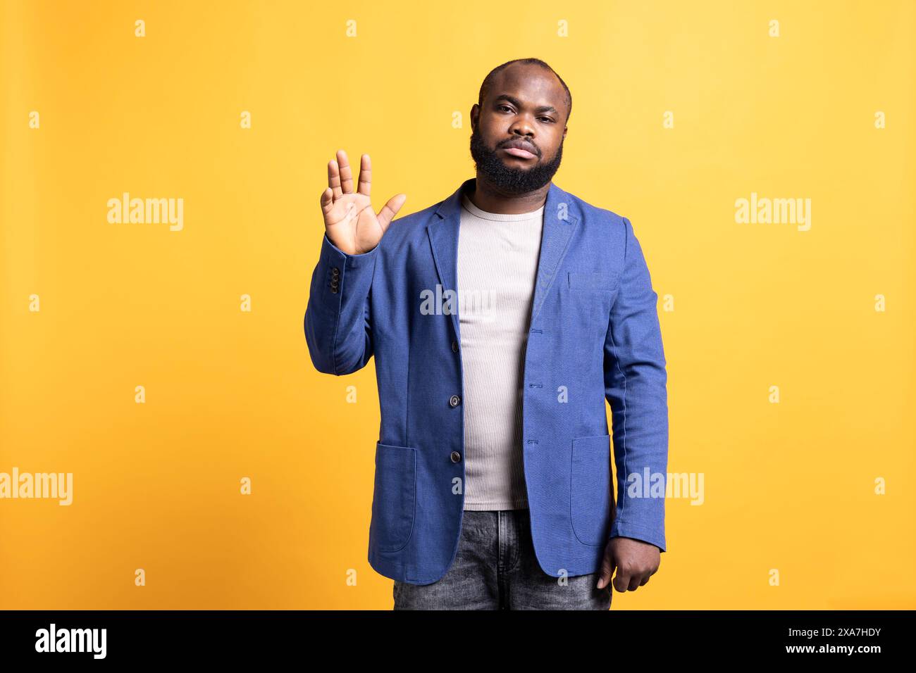 African american man reluctantly doing salutation hand gesture ...