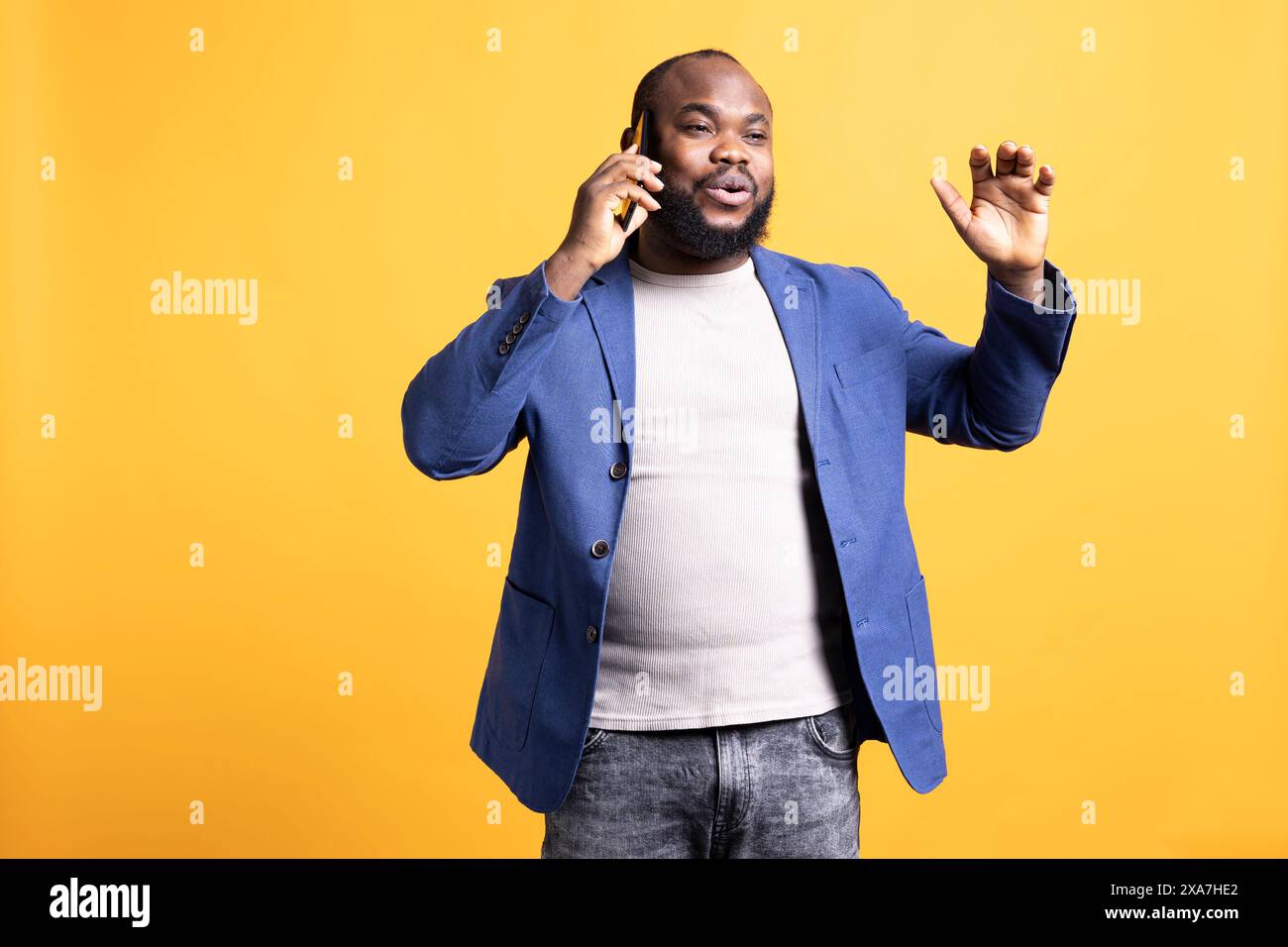 Joyous man with positive emotion, enjoying talking with friends phone ...