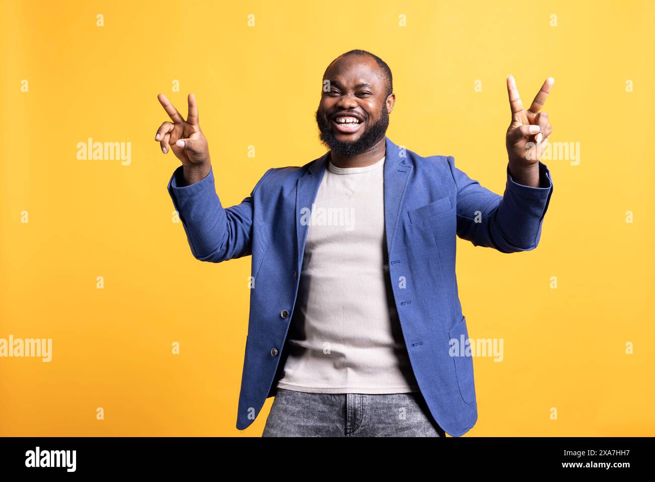 Portrait of cheerful man doing victory sign after winning, isolated ...
