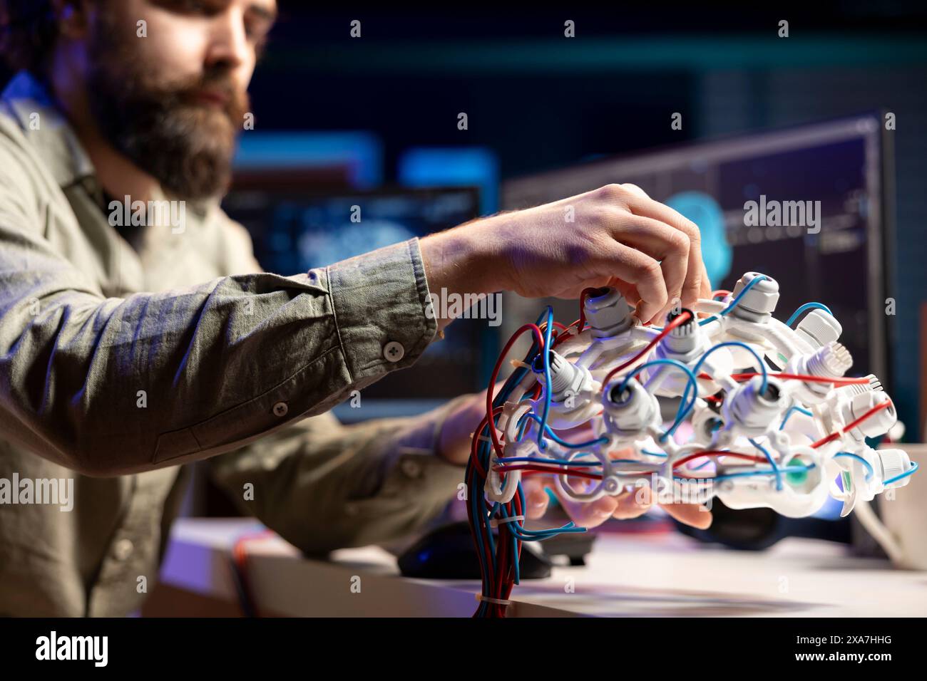 Computer scientist installing electrodes wires on EEG headset to ...