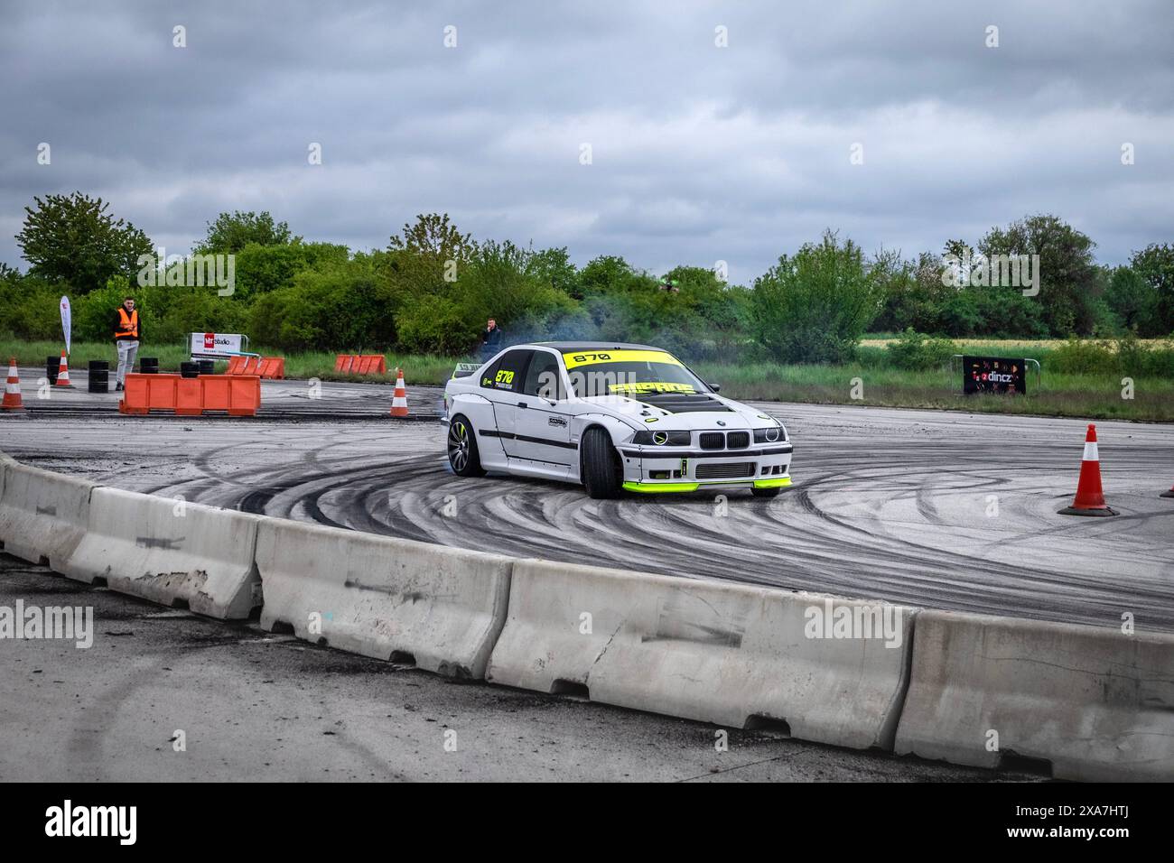 A white car racing on a track and drifting Stock Photo - Alamy