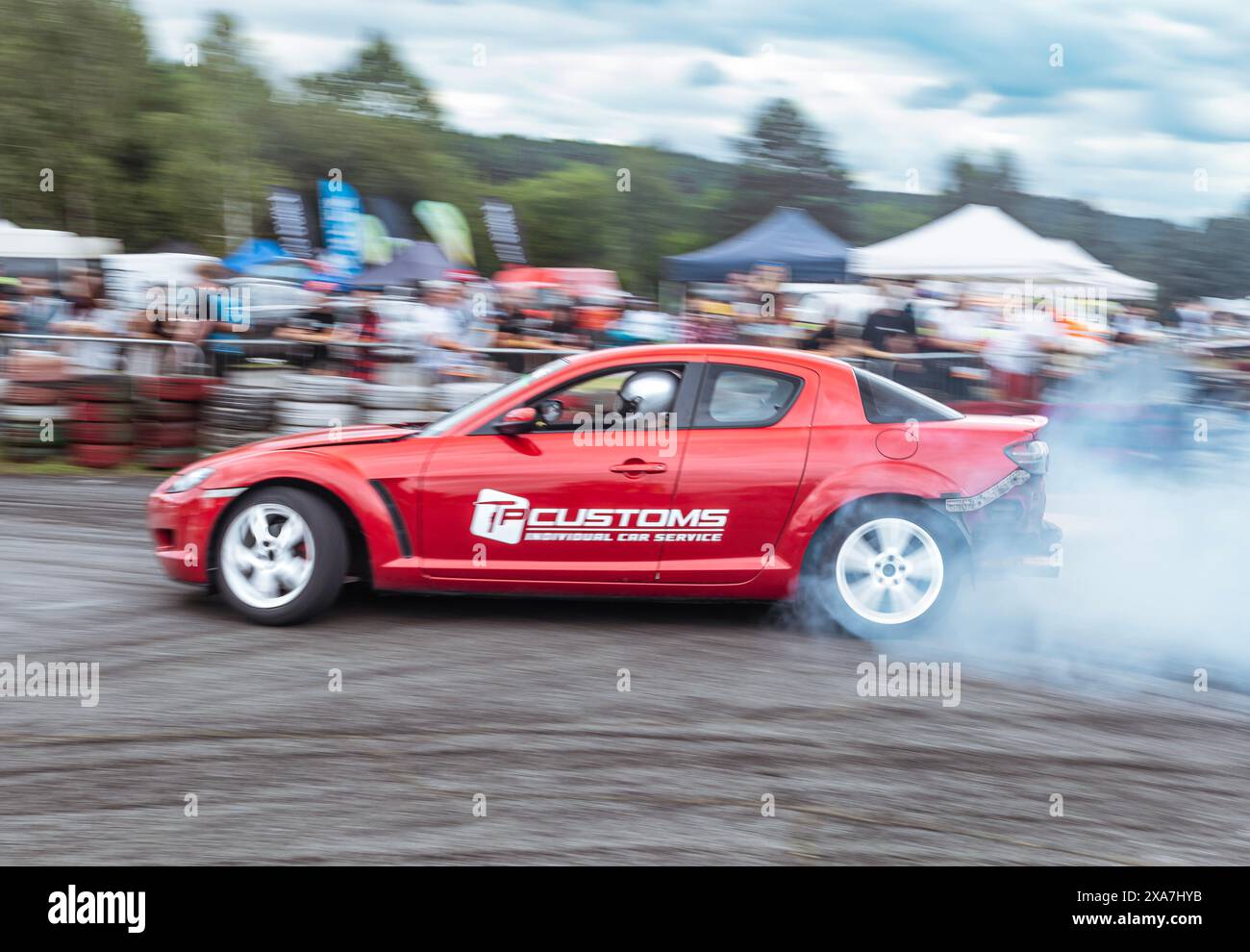 a red Sports car drifting with billowing smoke on a race track Stock ...