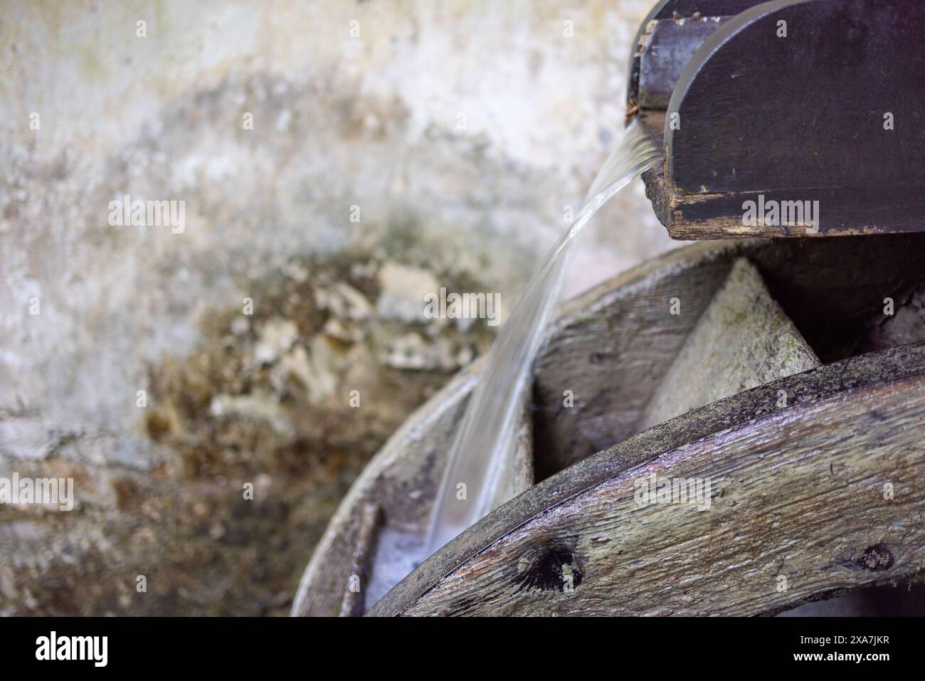 A water cascades from a wooden wheel barrel Stock Photo - Alamy