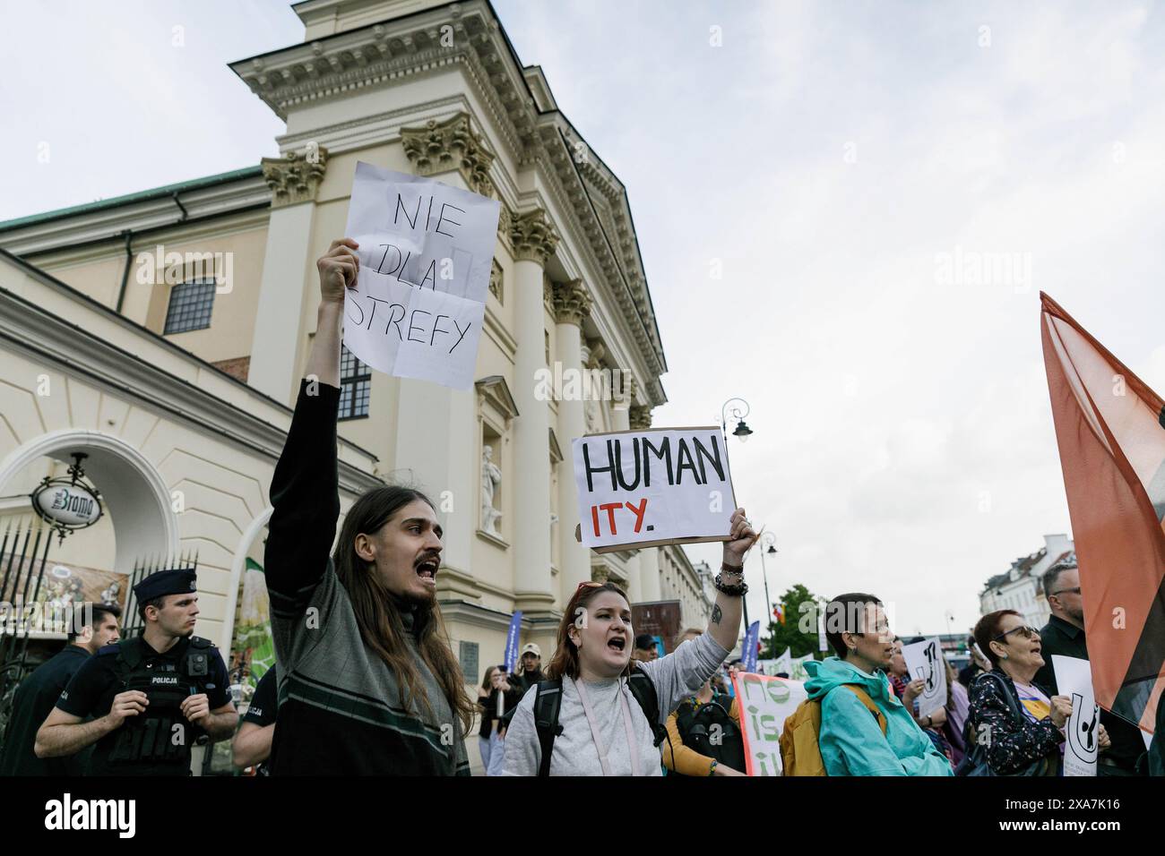 Protesters hold placards with the inscription "Not for the zone", and ...