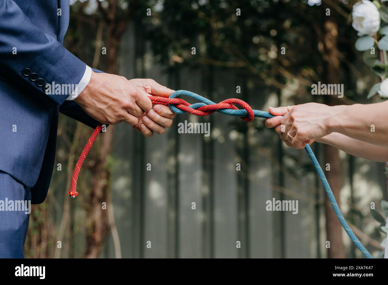Woman pulling rope with hands stretched out Stock Photo - Alamy