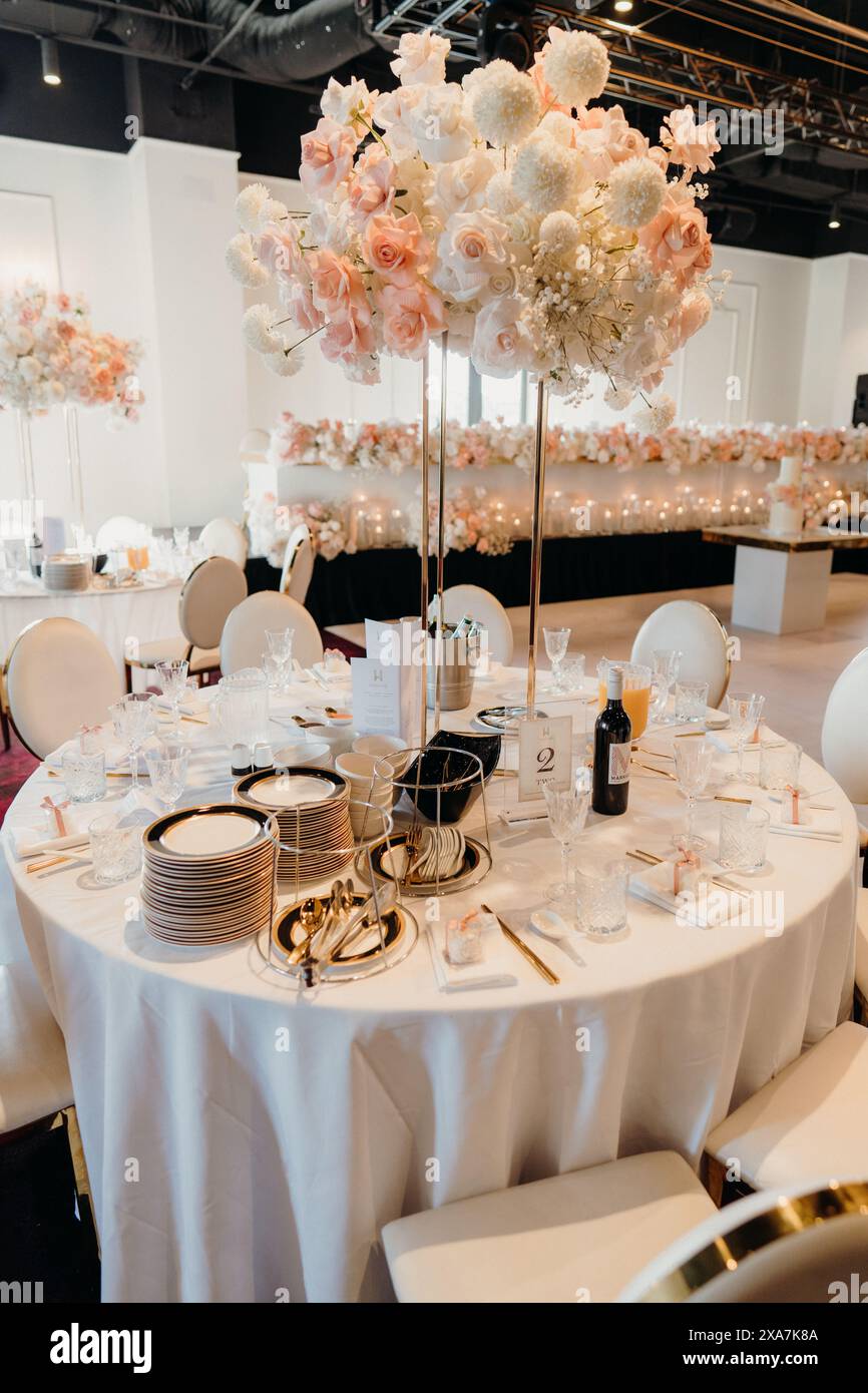 Elegantly decorated banquet hall with place settings and floral ...