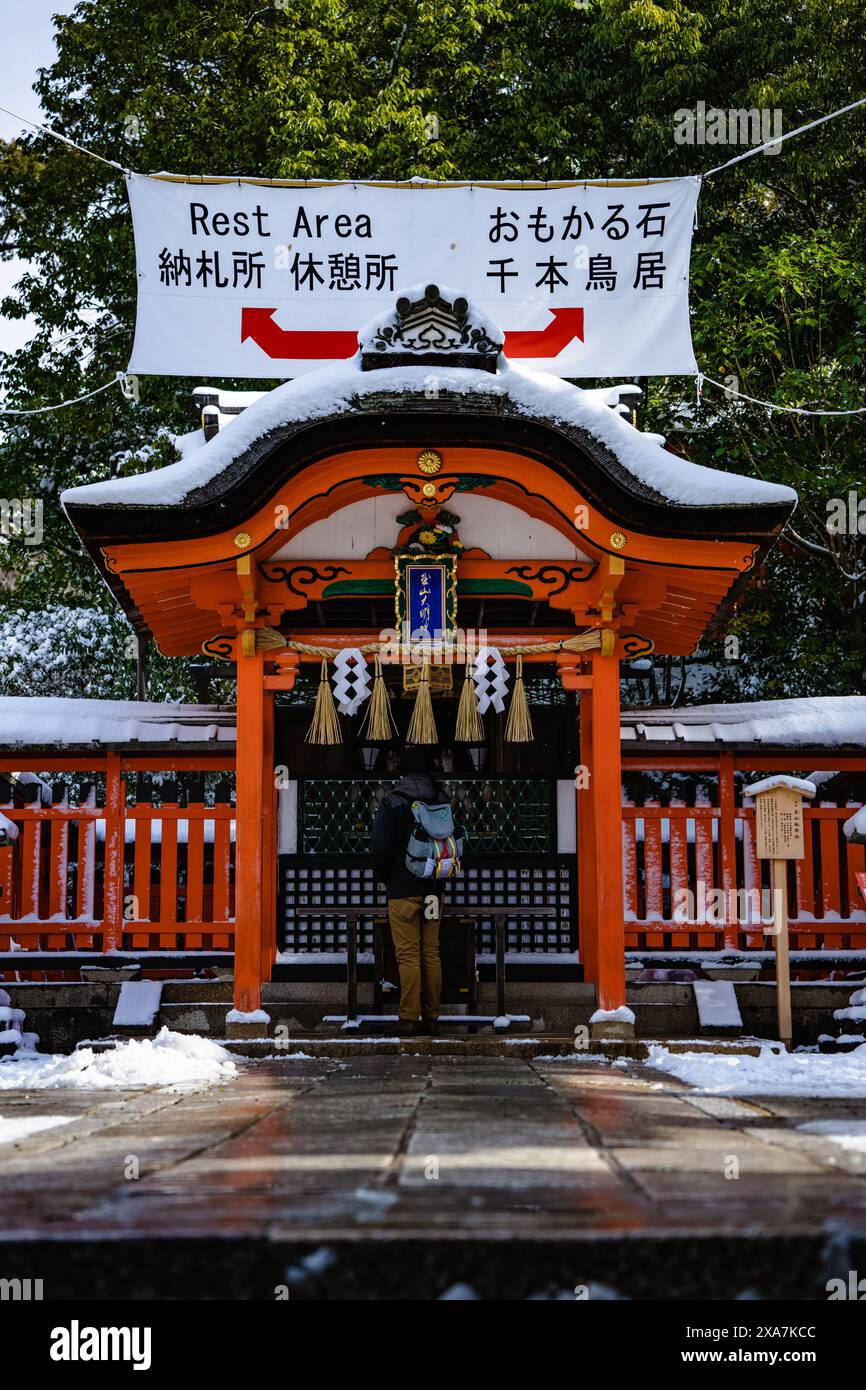 A Worshiper at Ancient style traditional Japanese gateway and temples ...