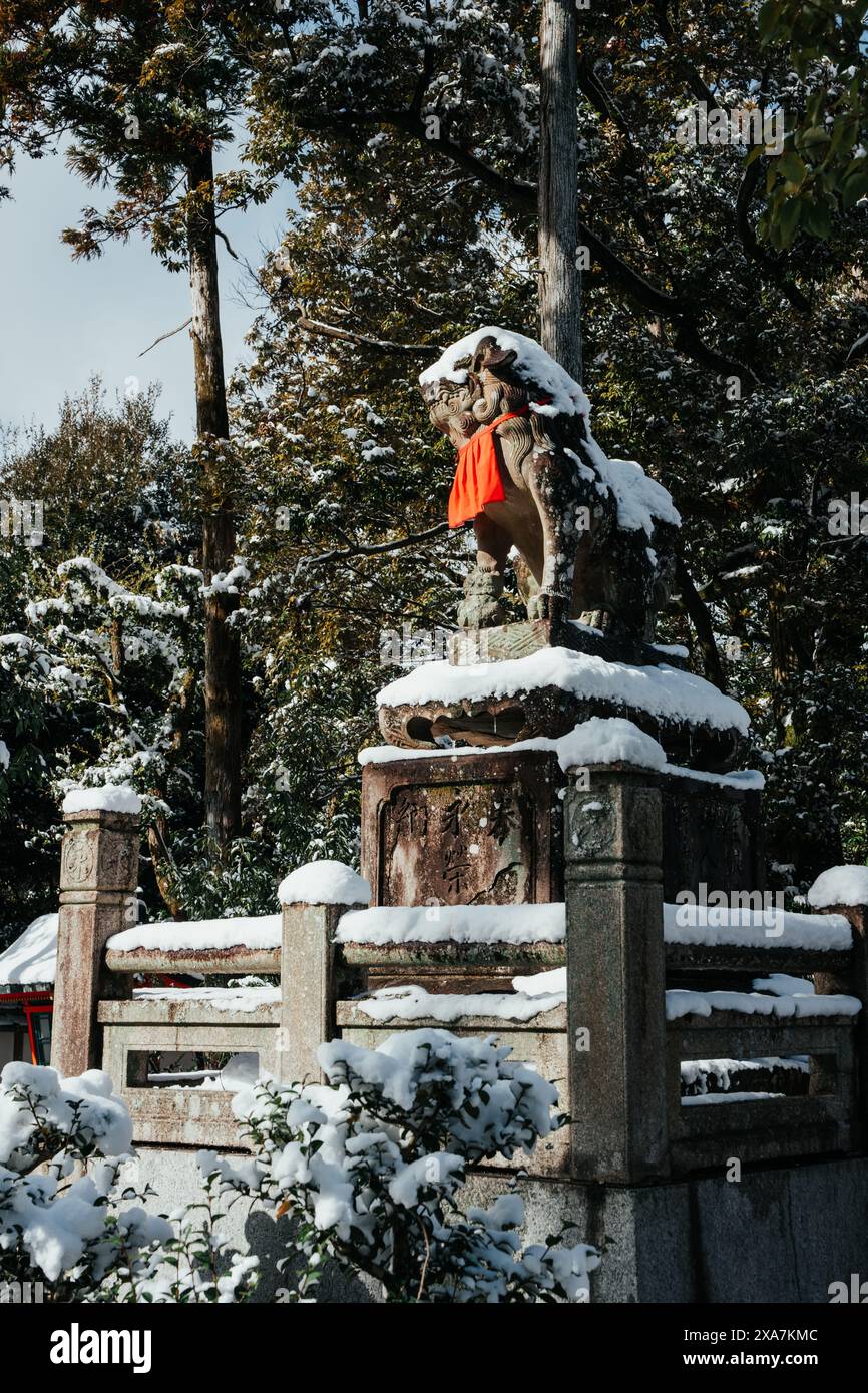 An Ancient style traditional Japanese statue covered in rare winter ...
