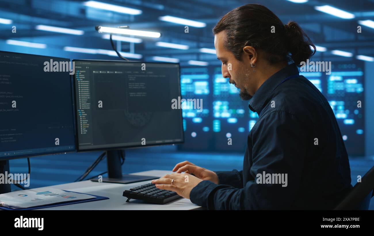 System administrator working in high tech server room capable of ...