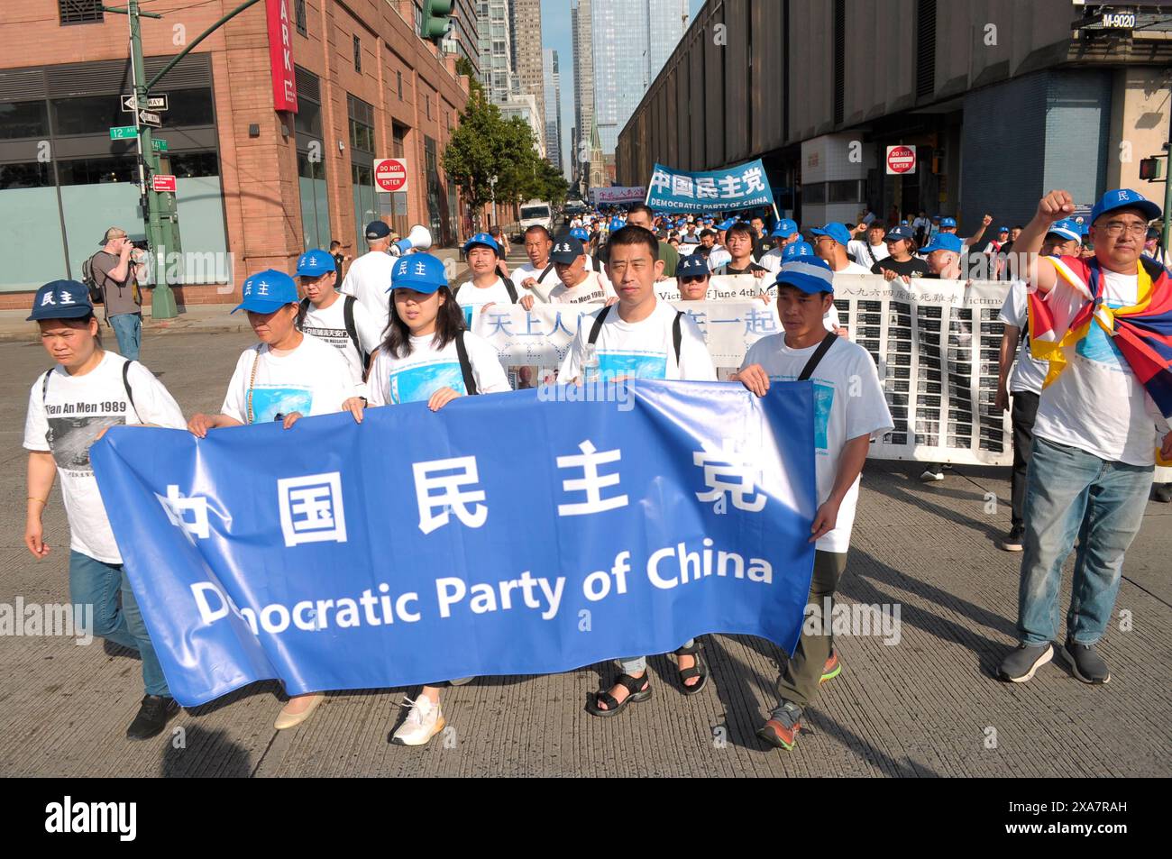 Anti-Chinese government demonstrators march holding a banner of the ...