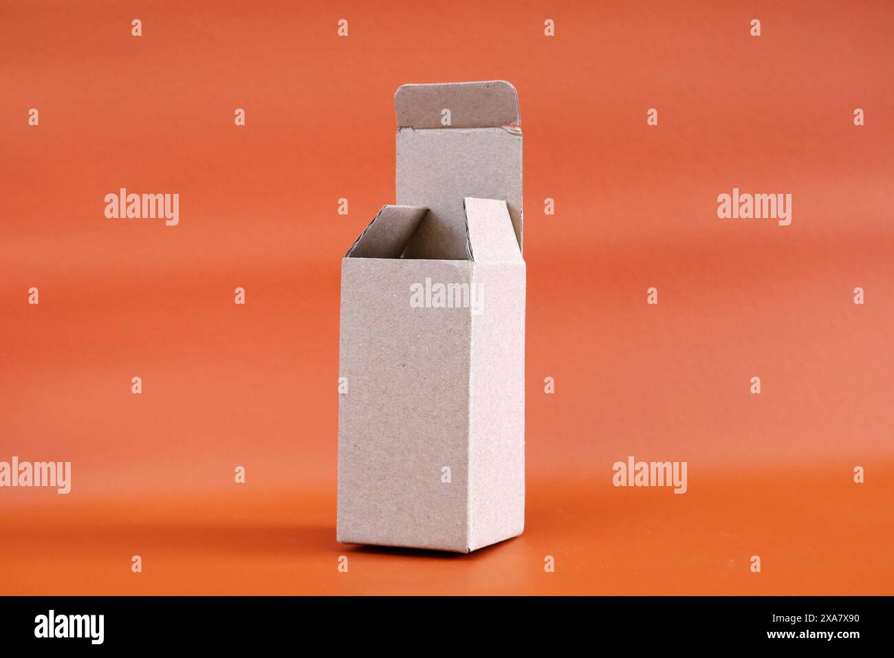 Empty brown tall cardboard paper box isolated on pink background ...