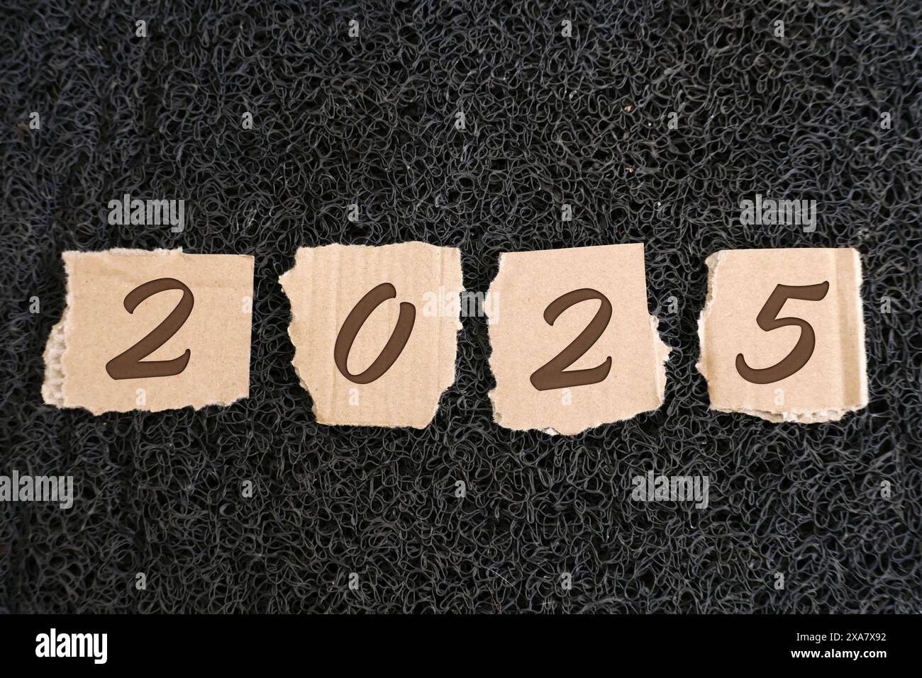Number 2025 on torn cardboard. 2025 new year concept Stock Photo - Alamy
